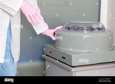 Hands Of Nurse Are Using Centrifuge Machine In Medical Lab Stock Photo Alamy