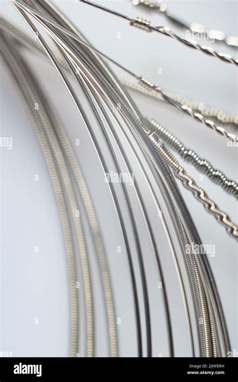 Macro Details Of Strings For Electric Guitar On A White Background