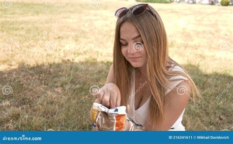 The Girl Eats Chips In The City Park In The Summer Stock Image Image