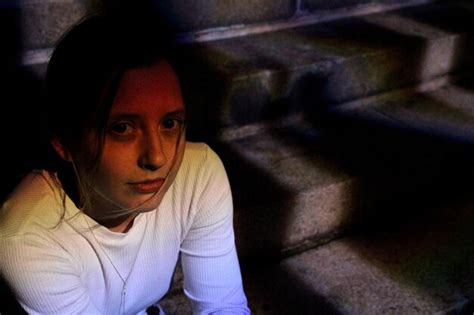 Premium Photo Portrait Of Young Woman Sitting On Staircase