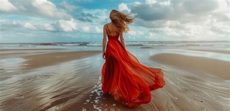 Premium Photo Elegant Woman In Flowing Red Dress On Beach
