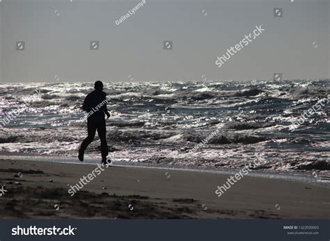 Man Running Along Beach Stock Photo Shutterstock