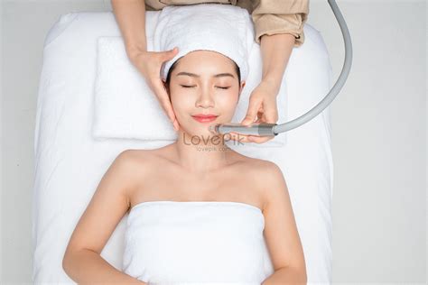 Female Lying On The Bed Doing Facial Treatment Picture And Hd Photos