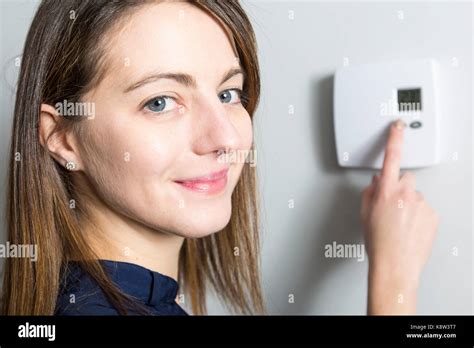 Woman Set The Thermostat At Home Stock Photo Alamy