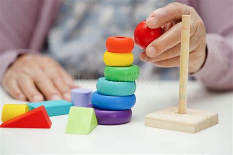 Asian Elderly Woman Playing Puzzles Game To Practice Brain Training For Dementia Prevention