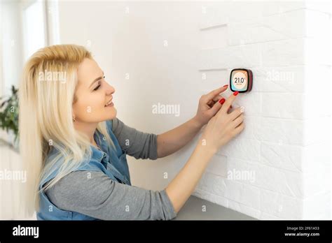 Smart Home Digital Thermostat Touch Screen Woman Touching Touchscreen To Adjust Temperature Of