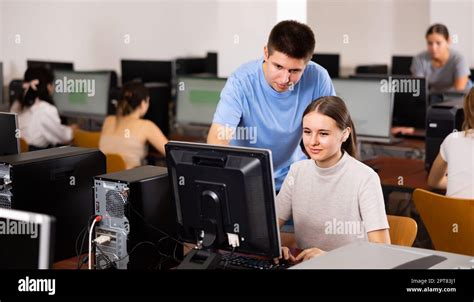 Smart Male Teenager Giving A Clue To The Female Co Learner While She Is Using Pc In The Computer