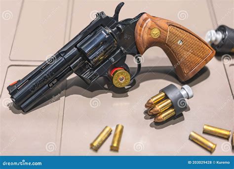 Replica Of A Black Revolver Colt Python 357 Magnum With Speed Loaders