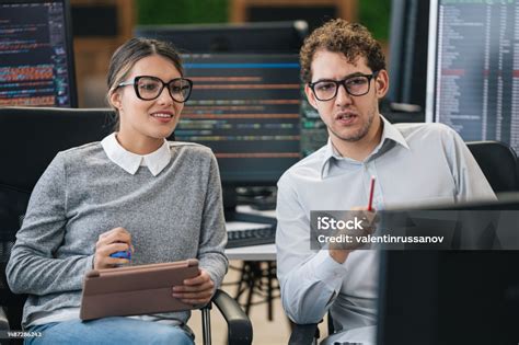 Software Programmers Analyzing Html Code And Database Brainstorming Script Ideas To Develop New