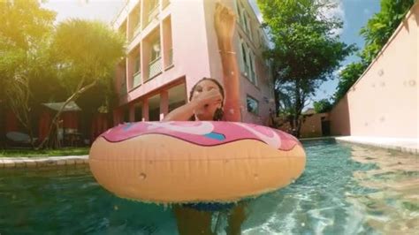 Woman Sunglasses Blue Bikini Lying Inflatable Pink Donut Float Pool