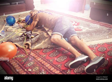 Party Drunk And Hangover With A Man Sleeping On A Living Room Floor