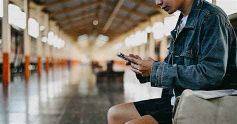 배낭 여행객 컨셉의 기차역에서 휴대 전화를 사용하는 여행자 사진 Unsplash의 사진술 이미지