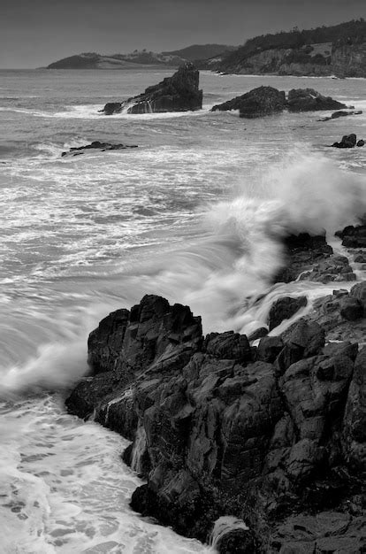 Premium Photo Black And White Image Of Waves Crashing On Rock Formations