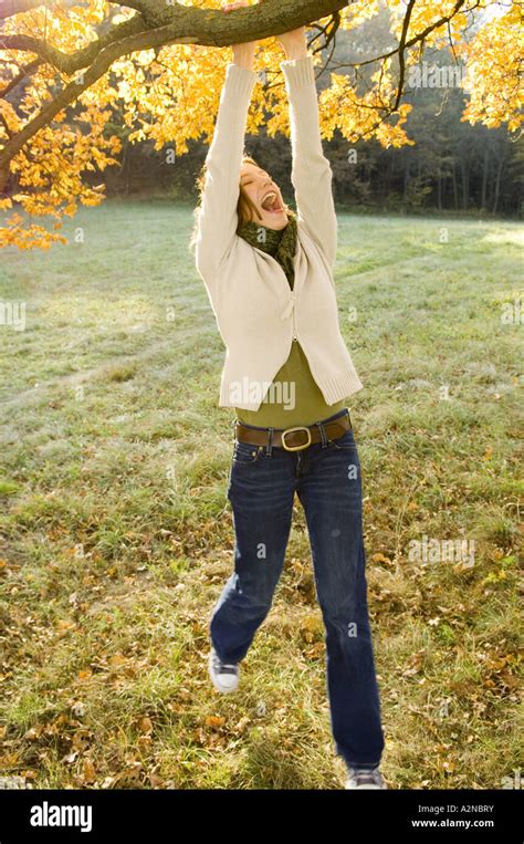 Girl Hanging From Tree Branch High Resolution Stock Photography And Images Alamy