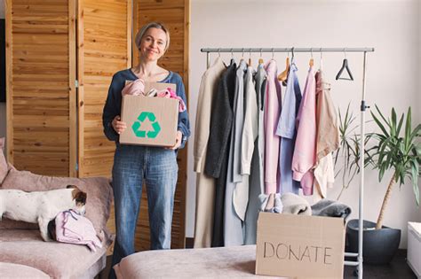 옷으로 골판지 재활용 상자를 들고있는 행복한 중년 여성 붙박이장에 대한 스톡 사진 및 기타 이미지 붙박이장 행복 40 44세 Istock