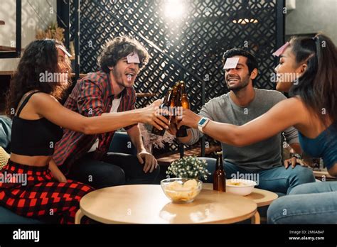 Group Of Happy Male And Female Friends Playing Name Game And Raising A