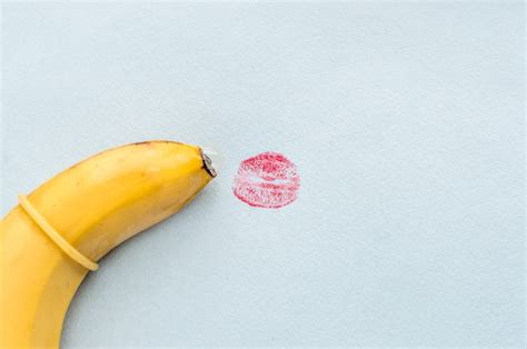 Premium Photo Banana In A Condom And An Imprint Of Red Lips Concept Oral Sex