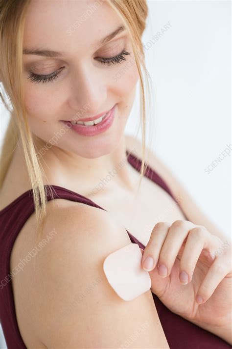 Woman Applying A Patch Stock Image C Science Photo Library