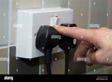 Someone Switching On An Electrical Socket Stock Photo Alamy