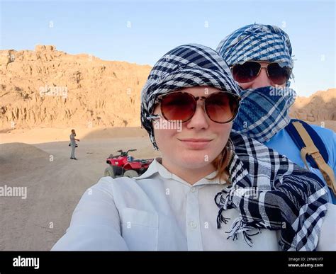 Tourists In Egypt On A Safari A Girl And A Man In The Desert On An