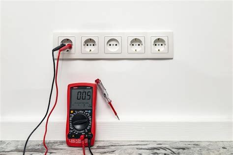 Premium Photo Checking The Voltage Of Electricity At A Home Outlet