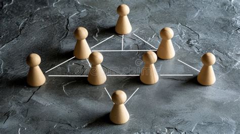 Network Or Hierarchy Concept With Wooden Figures Connected By Black Lines On A Dark Textured Network Or Hierarchy Concept With Wooden Figures Connected By Black Lines On A Dark Textured