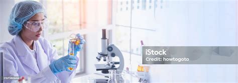 배너 과학자 여자가 화학 테스트 노란색 유리관 테스트 과학 실험실을 들고 있습니다 금색 액체 스포이드 유리관 소변 샘플을 들고 있는 실험실 기술자 아시아 여성 과학자 와