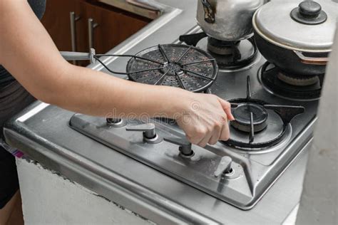 Girland X27s Hand Lighting The Burner To Light The Gas Stove And Prepare