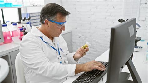 Mature Scientist Analyzing Medication While Using Computer In Laboratory Stock Video Video Of