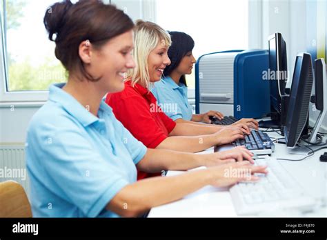 Female Workers Sitting On Computer Work Stations Stock Photo Alamy