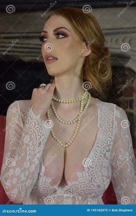 Beautiful Tall Slim Busty Redhead Model Dressed In A White Lace Dress In An Old Manor House
