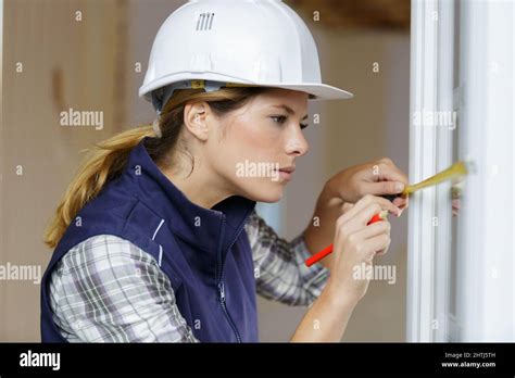 Portrait Of A Woman Measuring Window Frame Stock Photo Alamy