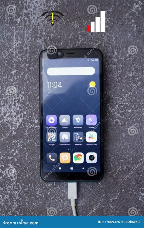 The Mobile Phone Is Connected To The Charger And The Battery Capacity