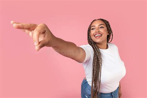 Black Plus Size Female Giving Invisible Object Over Pink Background Stock Image Image Of Woman