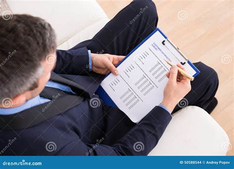 Businessman Filling Customer Survey Form Stock Photo Image Of Couch
