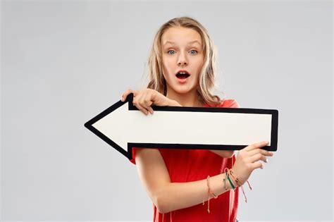 Premium Photo Teenage Girl With Arrow Showing Direction