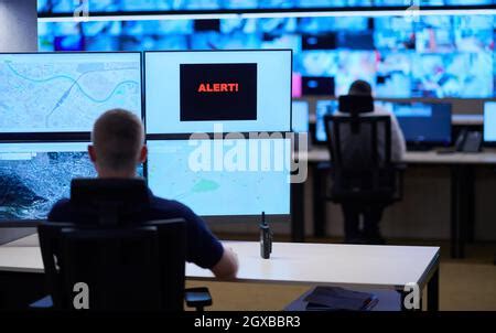 Male Security Operator Working In A Data System Control Room Offices