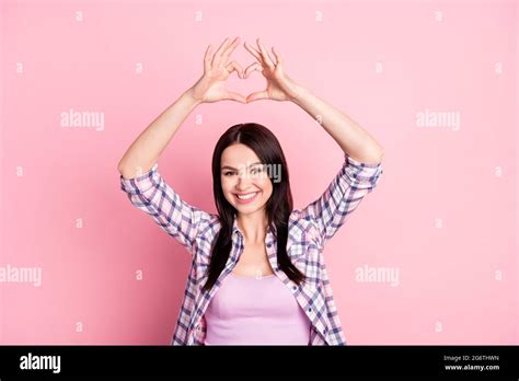 Photo Of Peaceful Coquette Girlfriend Make Heart Symbol Wear Plaid Shirt Isolated On Pink Color
