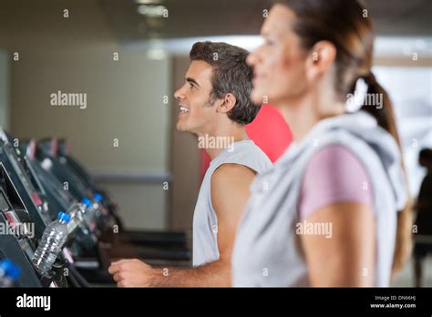Man And Woman Running On Treadmill Stock Photo Alamy