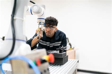 Premium Photo Engineer Check And Control Automation Robot Arms Machine In Intelligent Factory