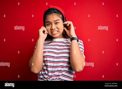 Young Beautiful Asian Girl Wearing Casual Striped T Shirt Over Isolated
