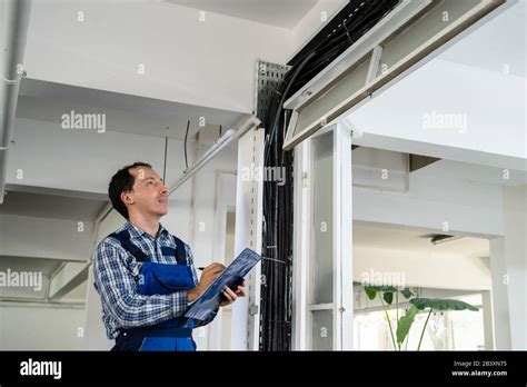 Portrait Of Male Male Electrician Installing Cables Stock Photo Alamy