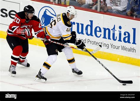 New Jersey Devils Matt Taormina 20 Tries To Get The Puck Away From