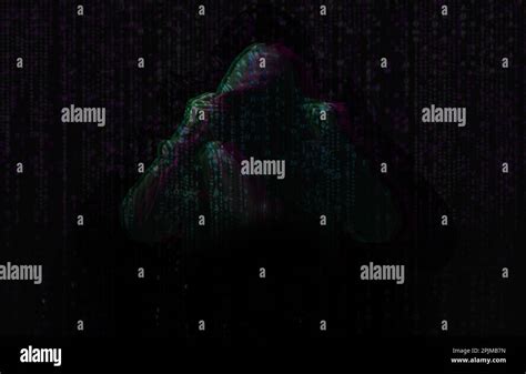Silhouette Of Anonymous Hacker And Digital Binary Code On Dark