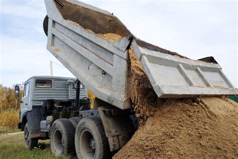 A Dump Truck Unloads Sand In The Construction Site Stock Image Image