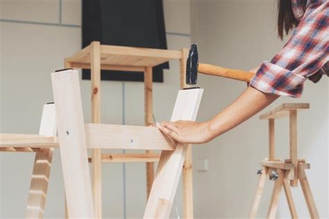 Premium Photo Midsection Of Woman Assembling Table In Workshop