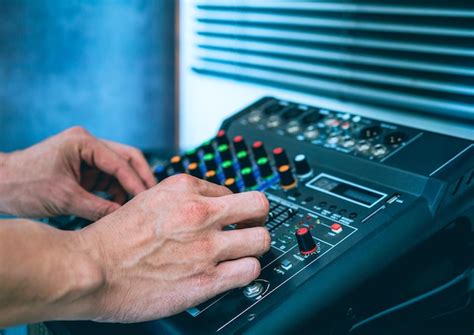 Premium Photo Sound Engineer Hands Adjusting Control Sound Mixer In
