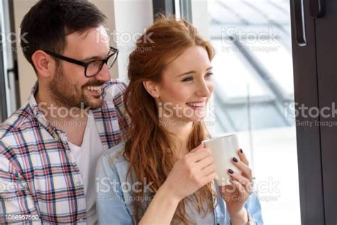 젊은 커플 서 그들의 새로운 아파트 마시는 커피의 창에 의해 결혼 창문 너머로 봄에 대한 스톡 사진 및 기타 이미지 창문 너머로 봄 기대 아파트 Istock