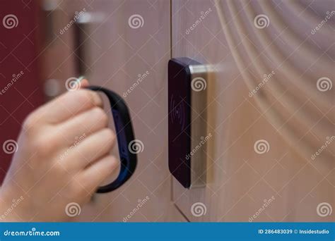 A Woman Opens The Electronic Lock Of A Cubicle In A Locker Room With A Bracelet Stock Image