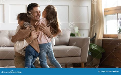 Happy Daddy And Cute Daughter Play Together Tickling On Sofa Stock